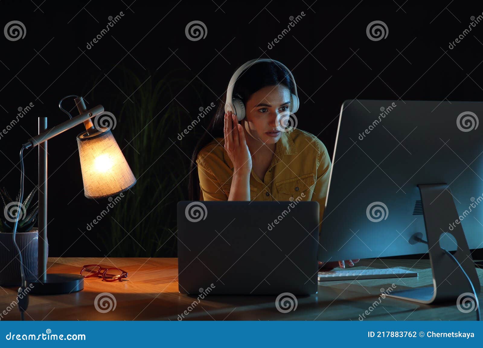 Programmer with Headphones Working in Office at Night Stock Photo ...