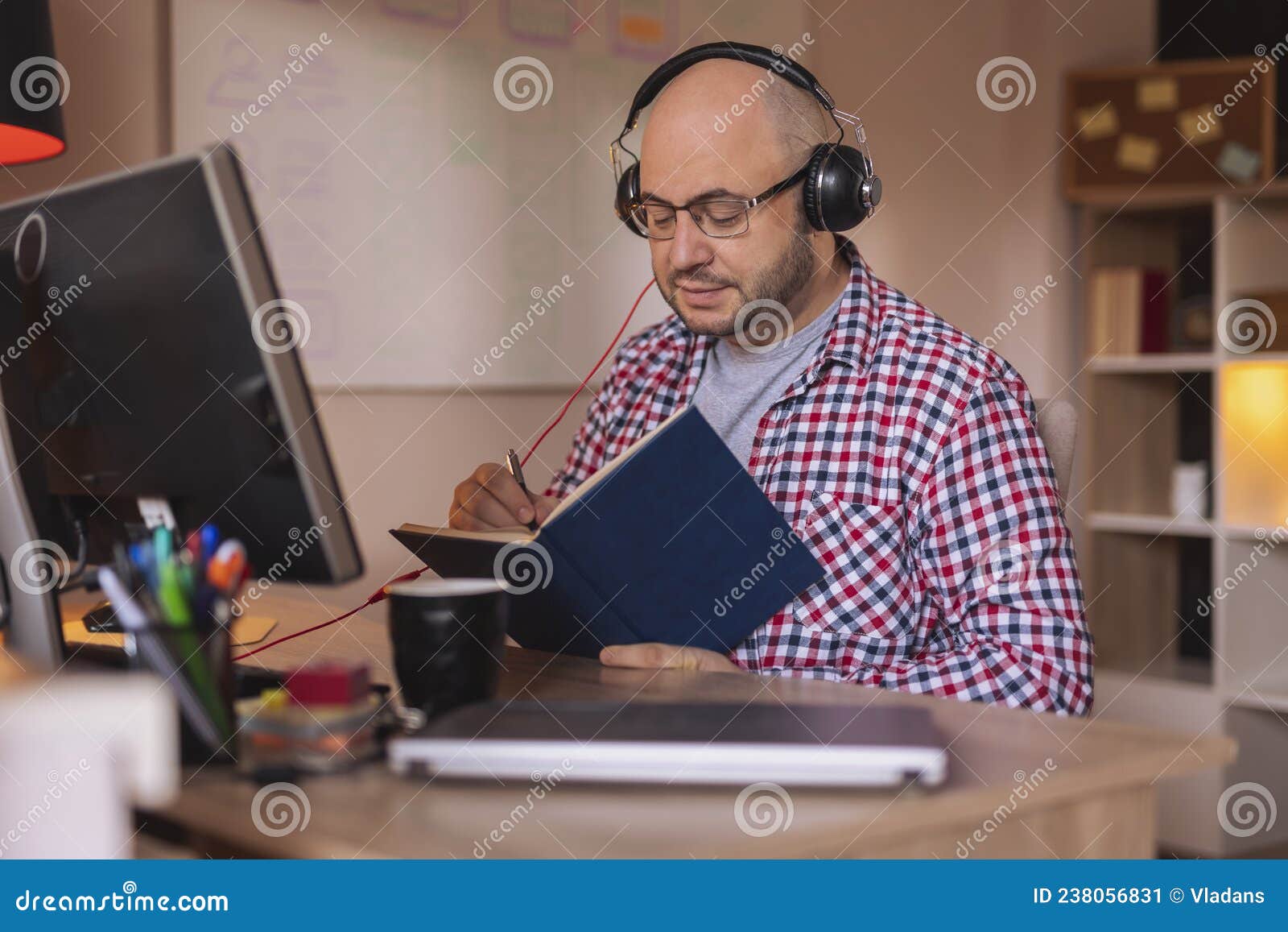 Programmer Taking Notes in Planner while Having Morning Briefing Stock ...