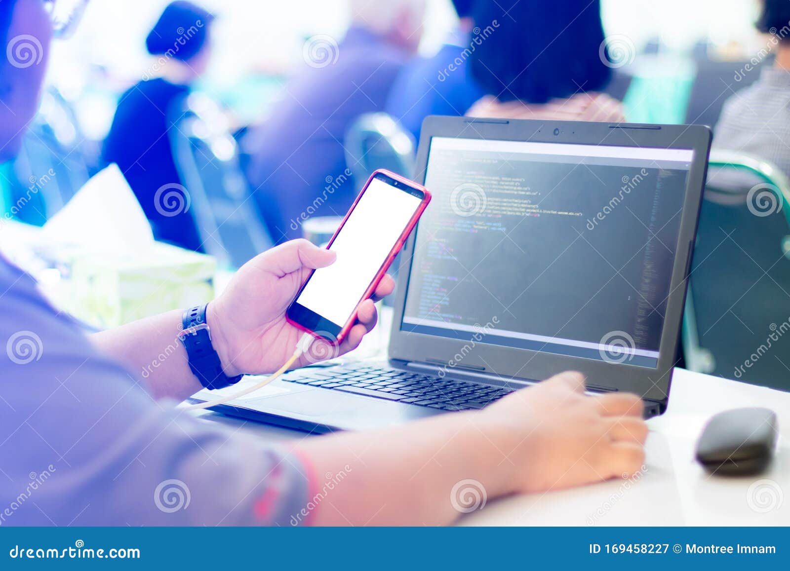 Programmer Working on Laptop at Office.and Test on Mobile Stock Image ...