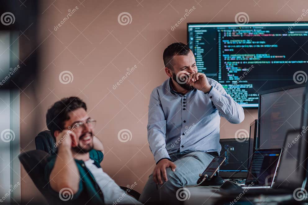 Programmers Engrossed in Deep Collaboration, Diligently Working ...