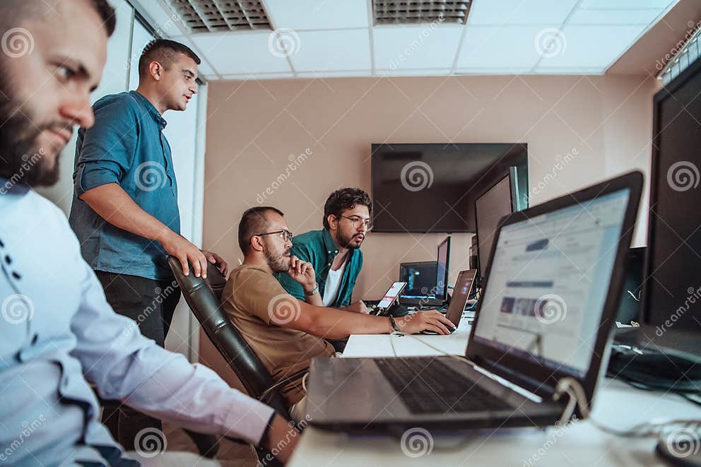 Programmers Engrossed in Deep Collaboration, Diligently Working Together To Solve Complex ...