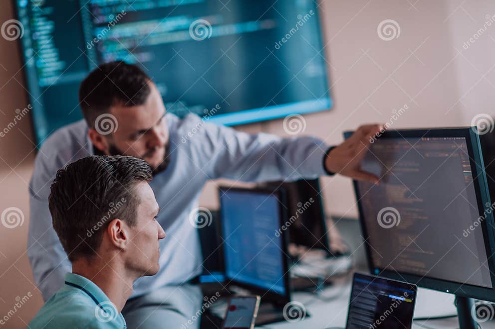 Programmers Engrossed in Deep Collaboration, Diligently Working ...