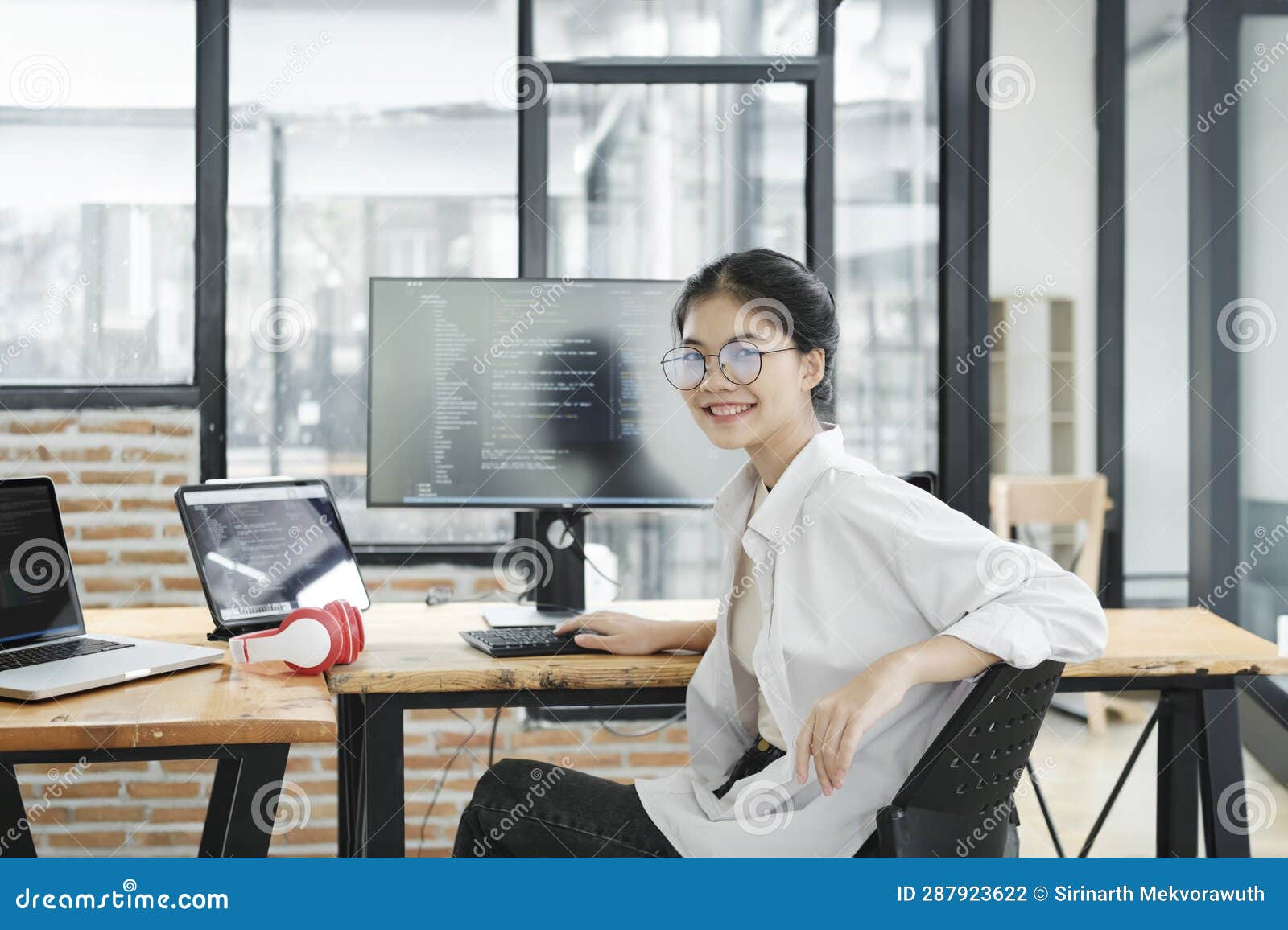 Young Programmer Working on Desktop PC in Office of Software Company ...