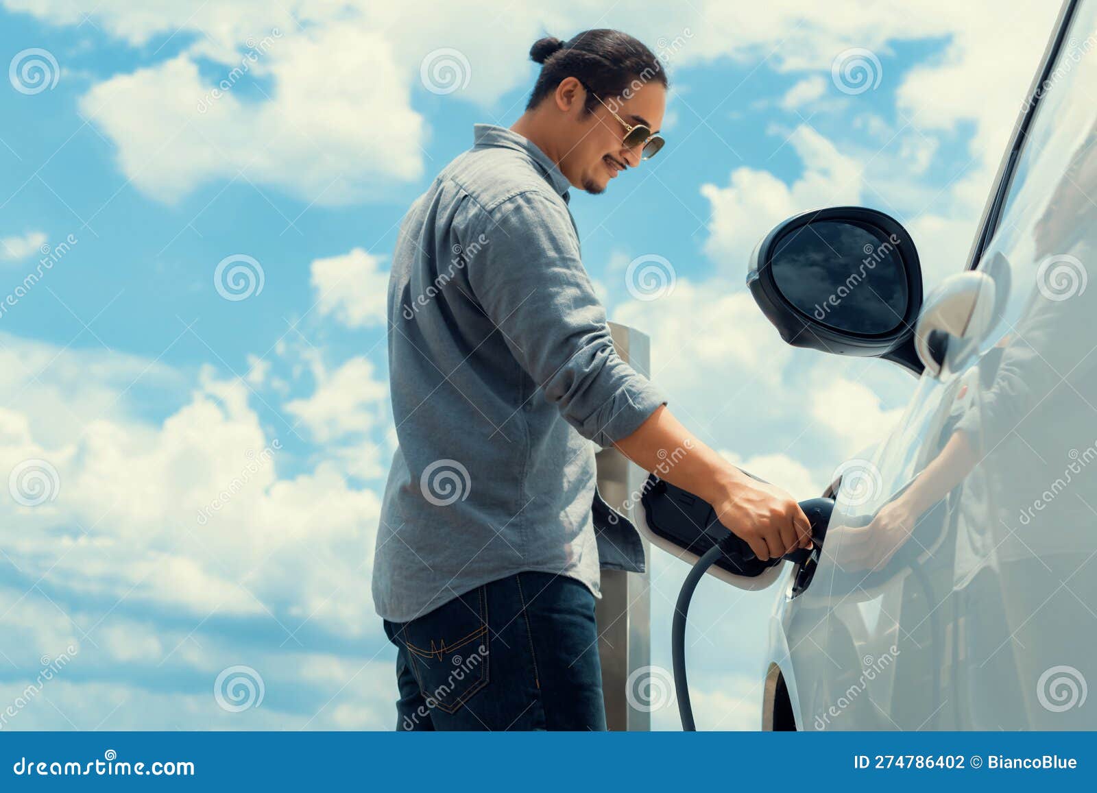 Progressive Man with Plugged-in EV Car with Charging Point, Cloudscape ...
