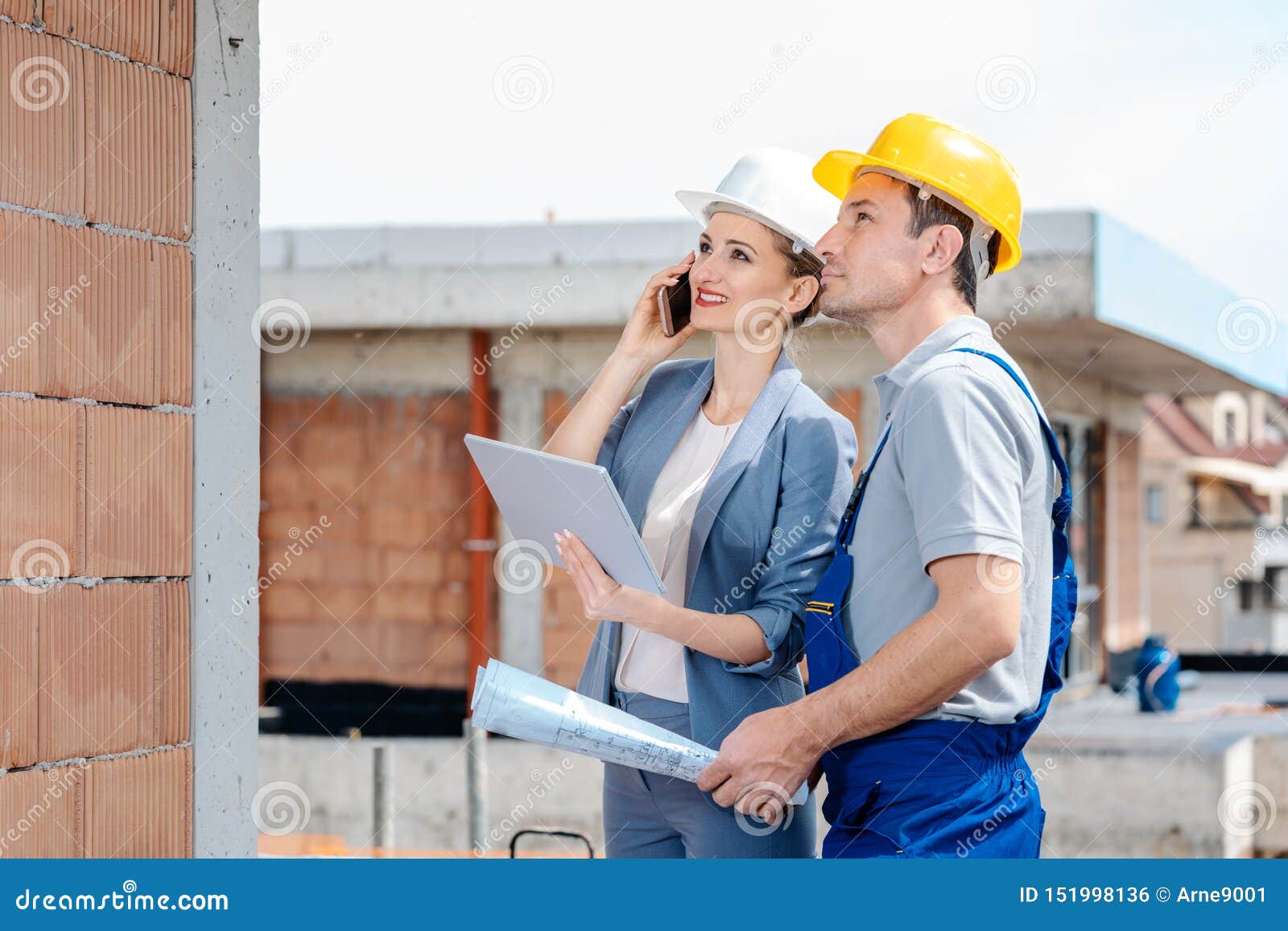 Project Developer and Construction Worker on Site Using Technology ...