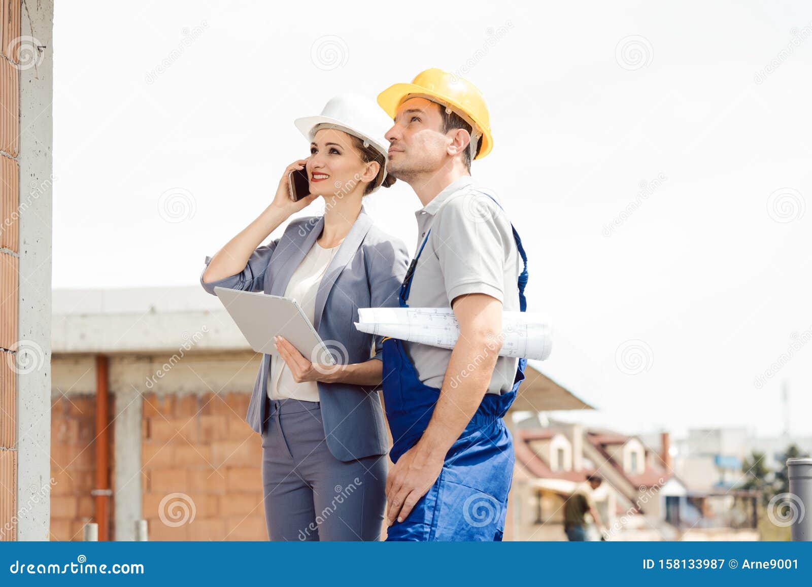 Project Developer and Construction Worker on Site Using Technology ...