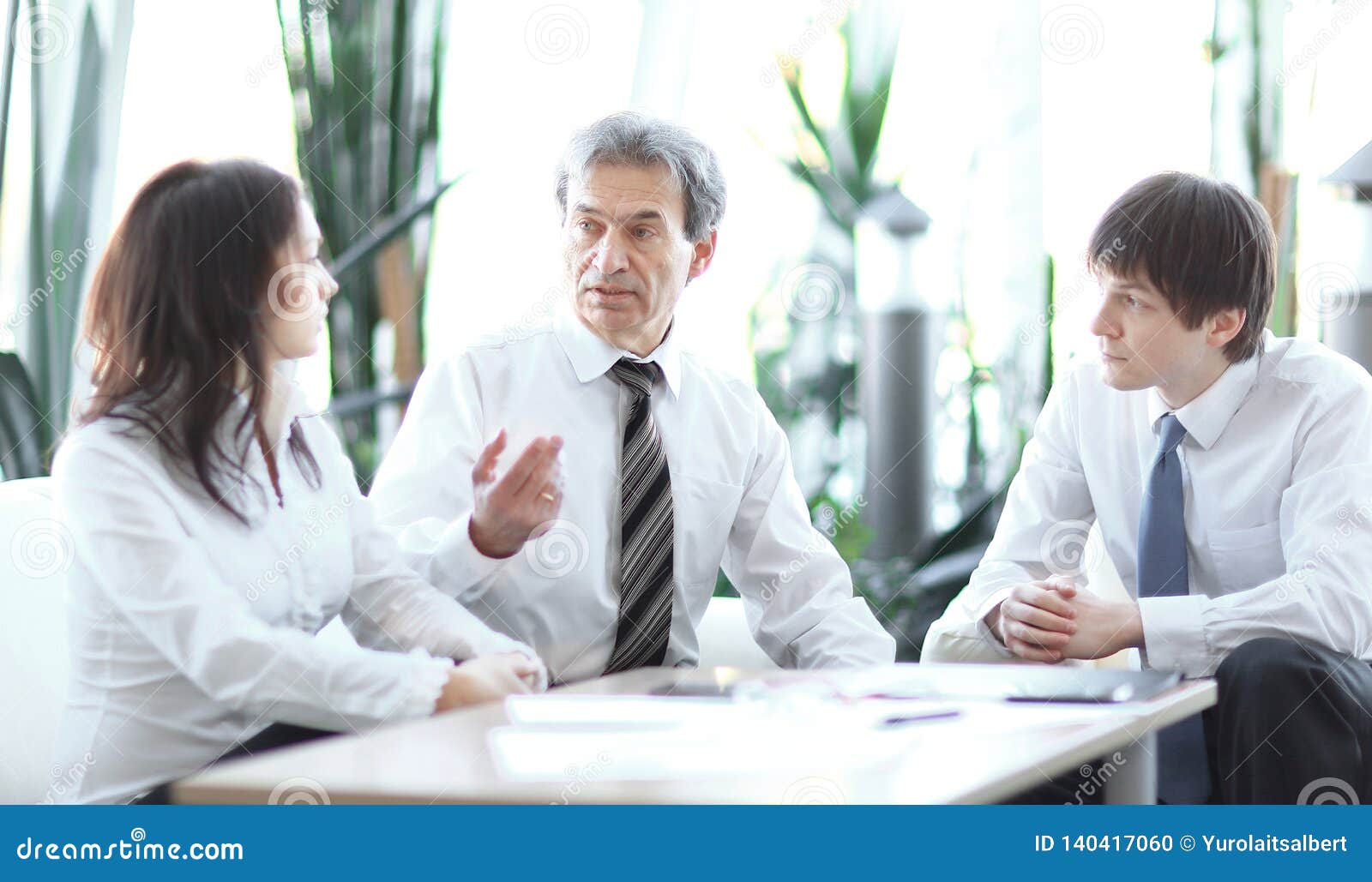 Project Leader Talking To Business Team in the Workplace. Stock Photo ...