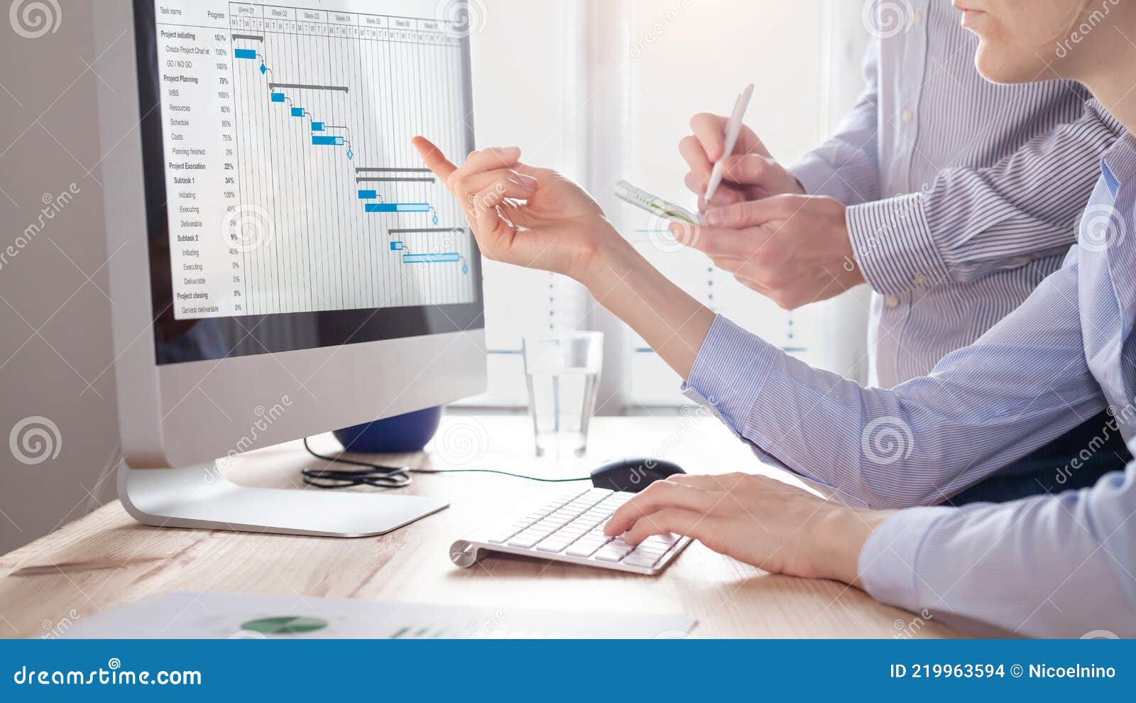Project Management Team Updating Planning Schedule with Gantt Chart on ...