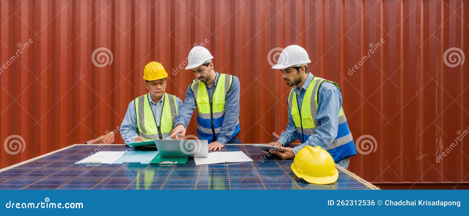 Project Manager Pointing at Shipping Schedule on Laptop Computer ...