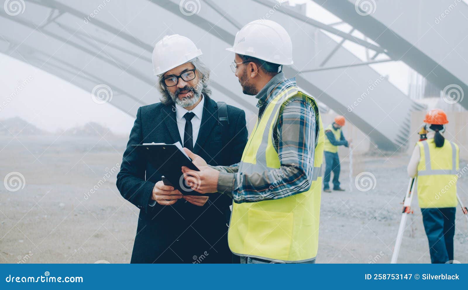 Project Manager Talking To Builder Discussing Construction Work Stock ...