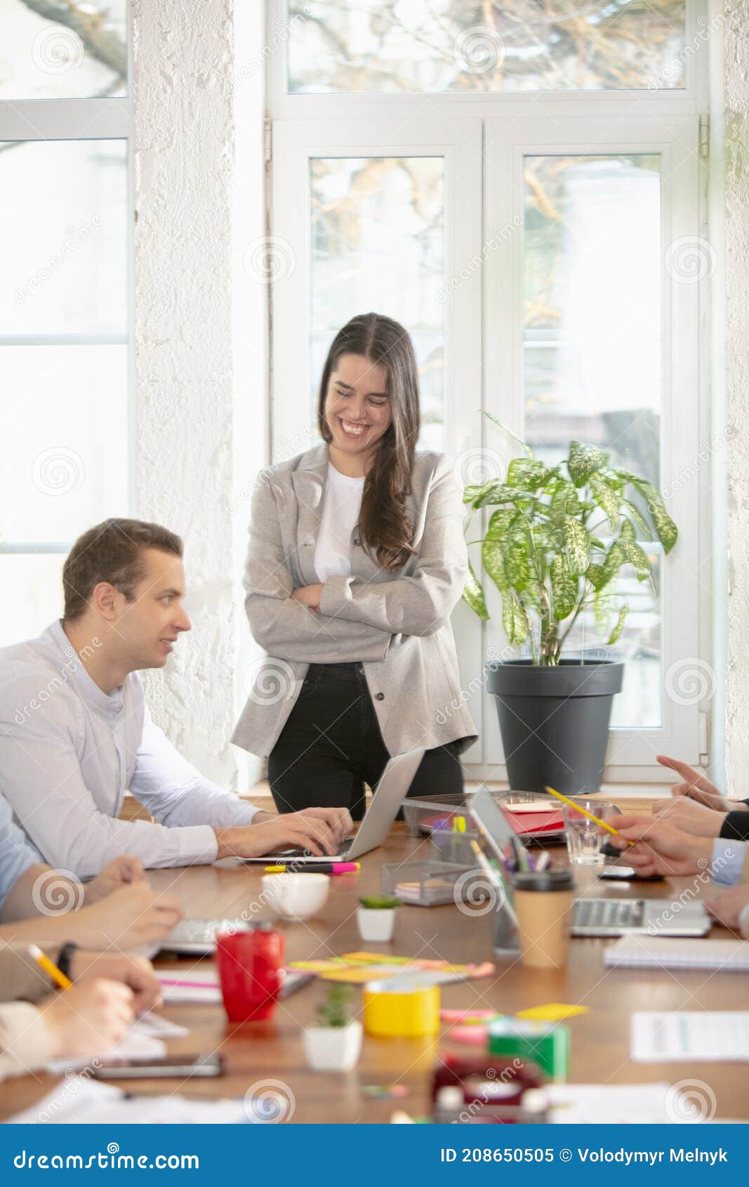 Side View Colleagues Working Together in a Office Using Modern Devices ...