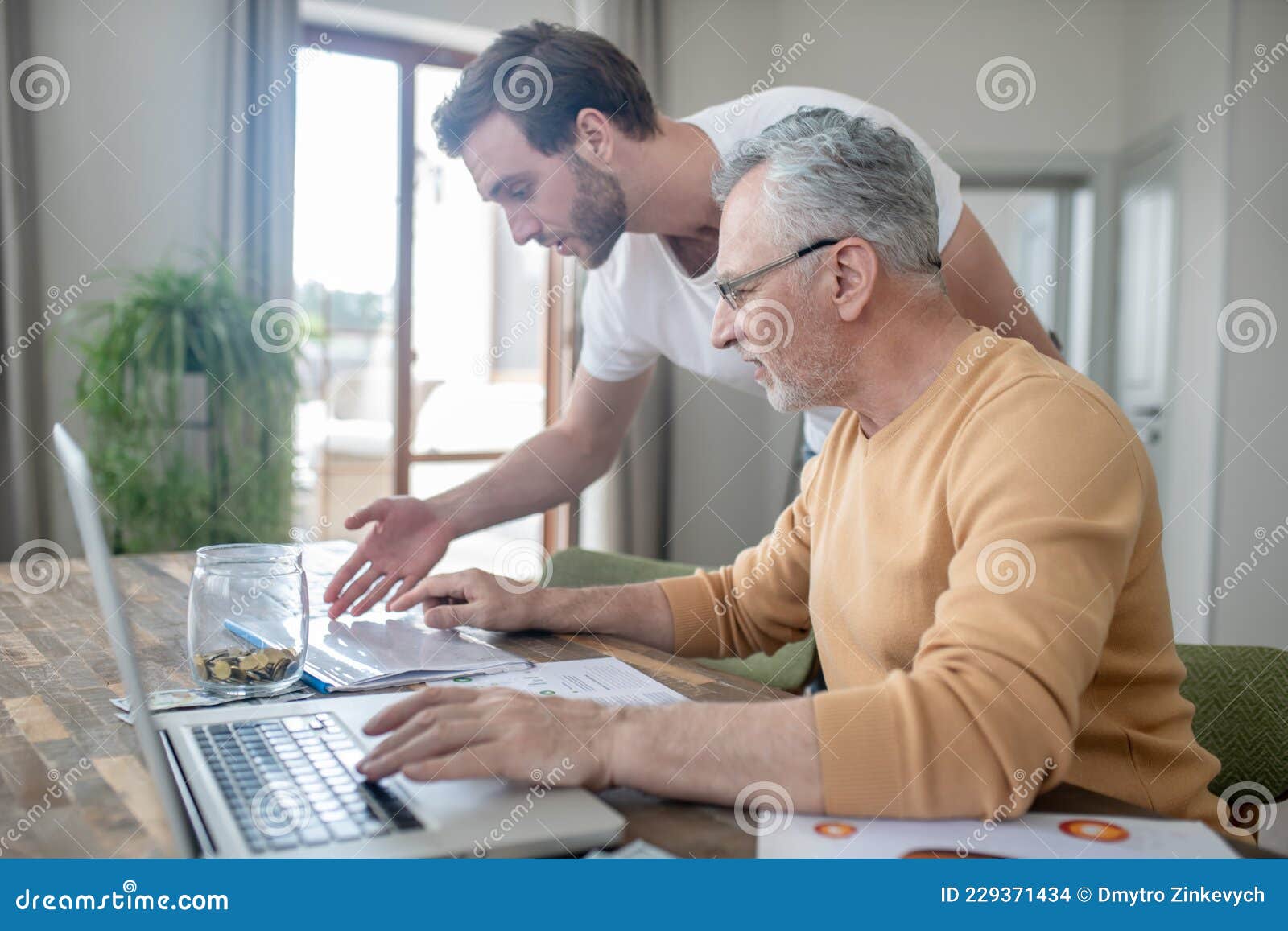 Two Men Working Together on a Project and Looking Interested Stock ...