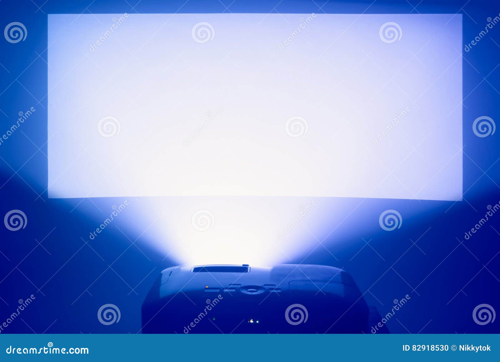 Projector in Action with Illuminated Warm Blue Screen Stock Photo ...