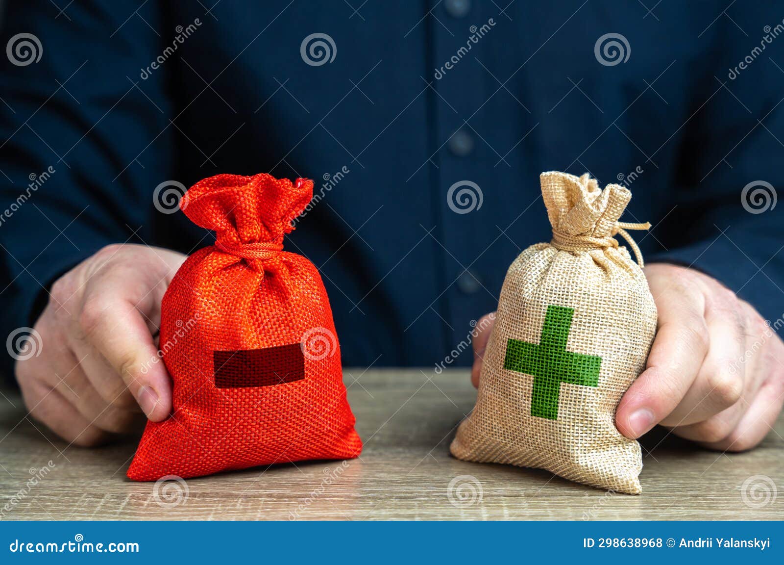 Pluses And Minuses Symbol. Businessman Turns A Wooden Cube And Changes ... Pluses And Minuses Symbol. Businessman Turns A Wooden Cube And Changes ...