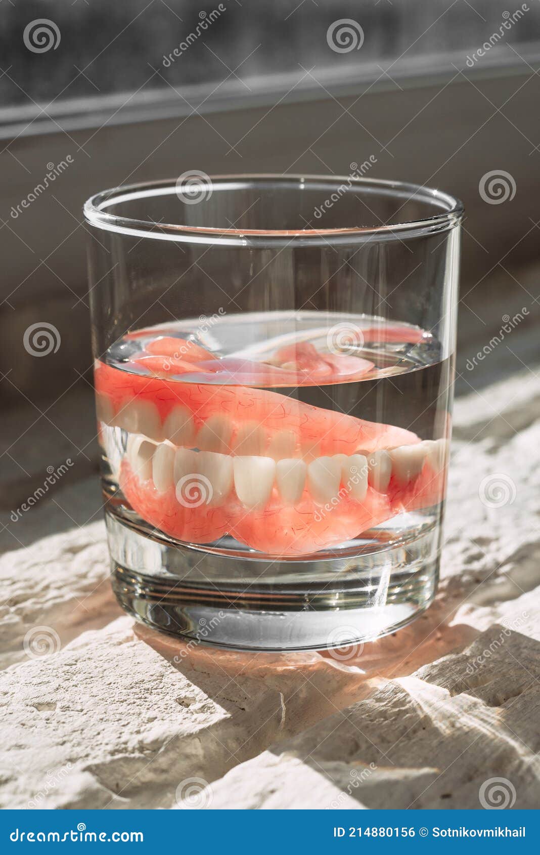 Prosthesis in a Glass with a Solution. Dental Prosthesis Care. Full ...