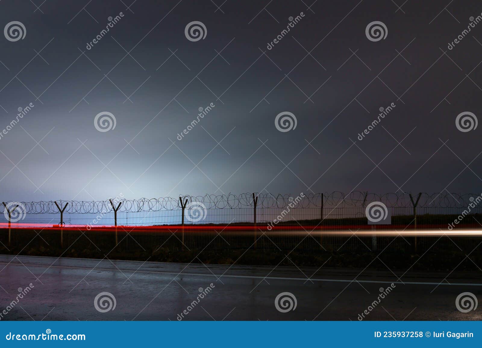 Protected Area Fence with Barbed Wire in the Dark of Night. Background ...