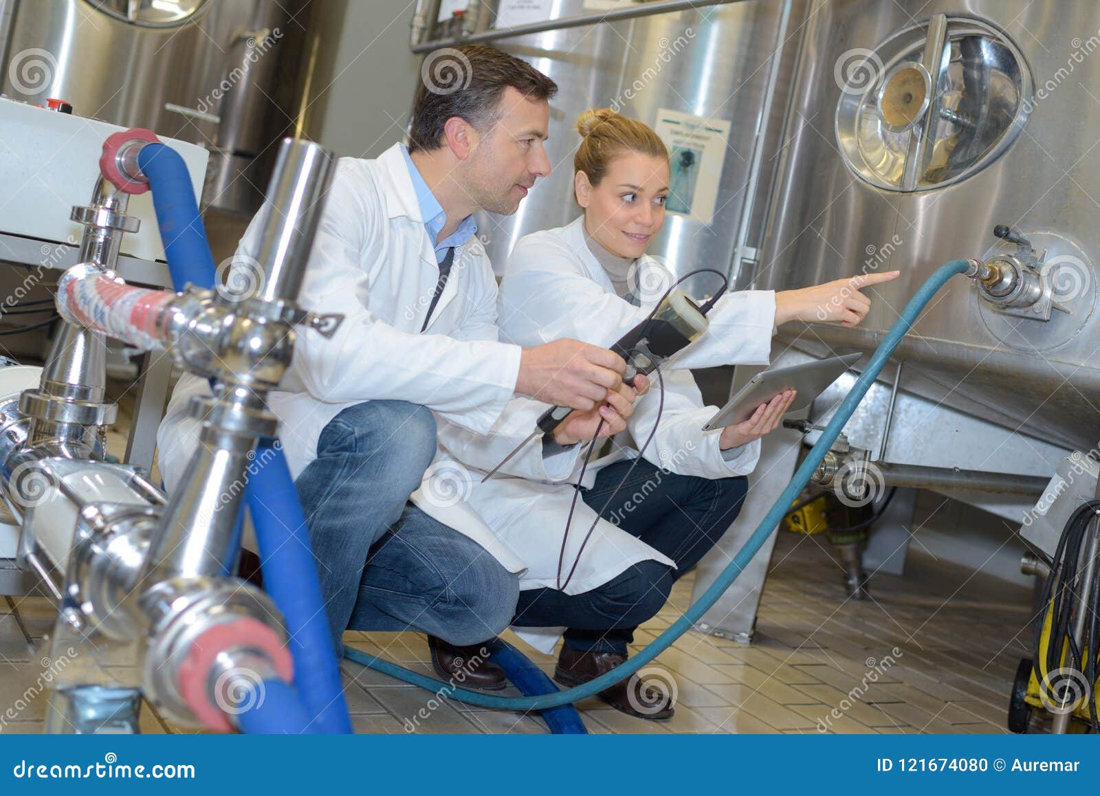 Protected Technicians in Uniform Working at Silver Tank in Factory ...