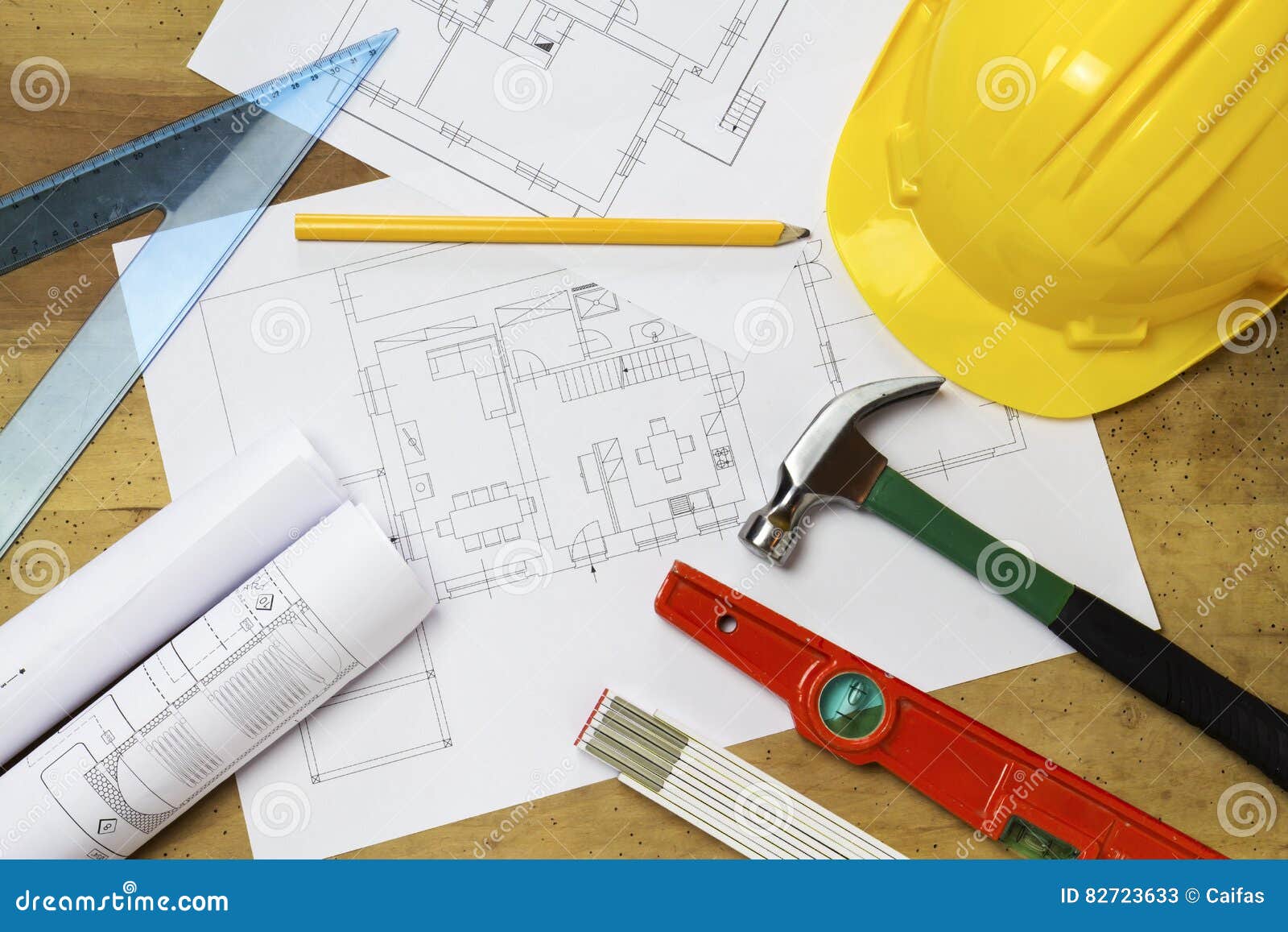 Protective Helmet, Mason Tools and Project Drawings on Wood Background ...