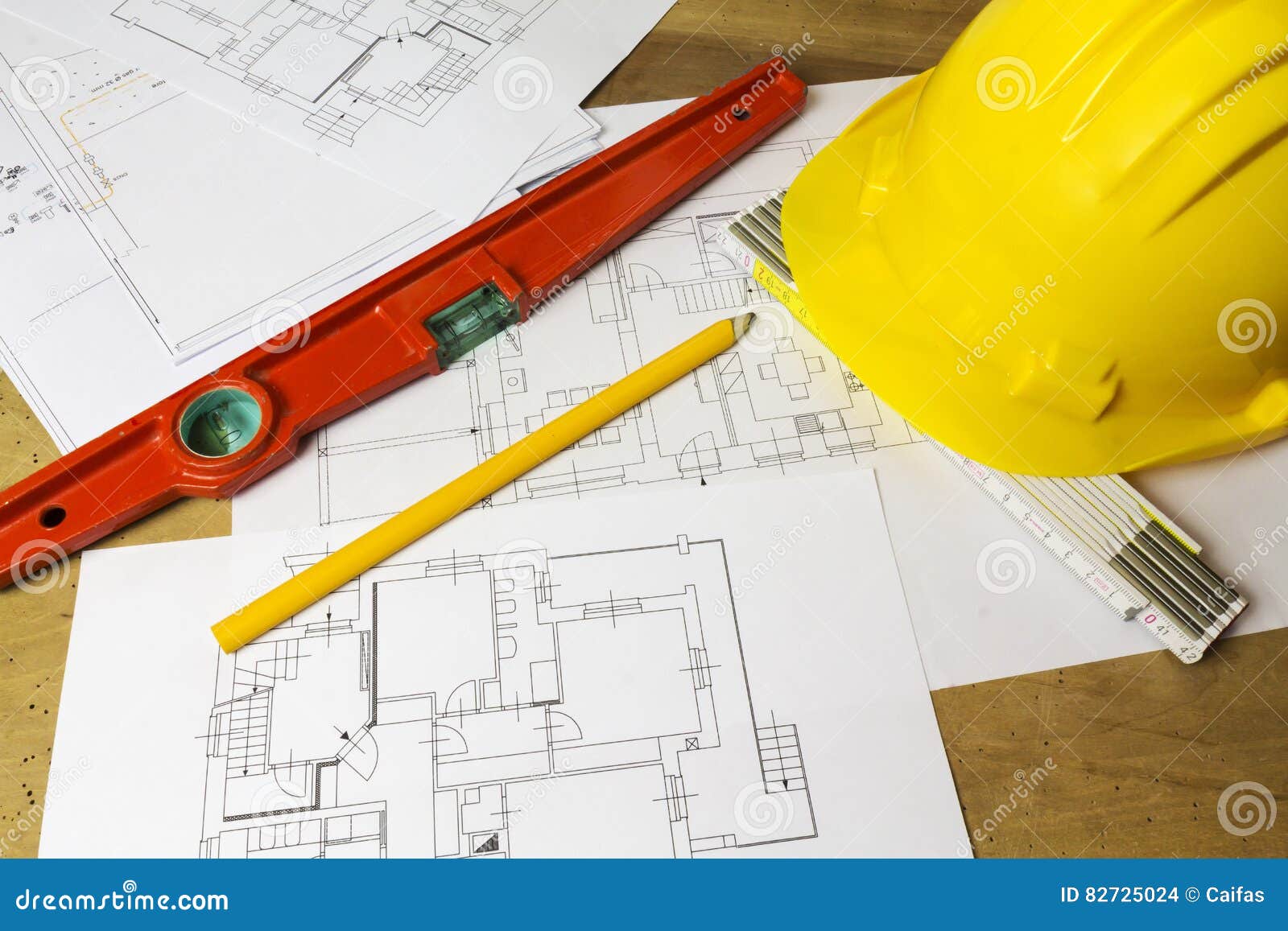 Protective Helmet, Mason Tools and Project Drawings on Wood Background ...