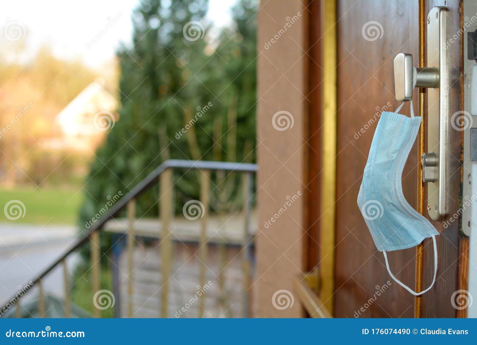 Protective Mask Hangs on the Open Front Door with a View Outside Stock ...