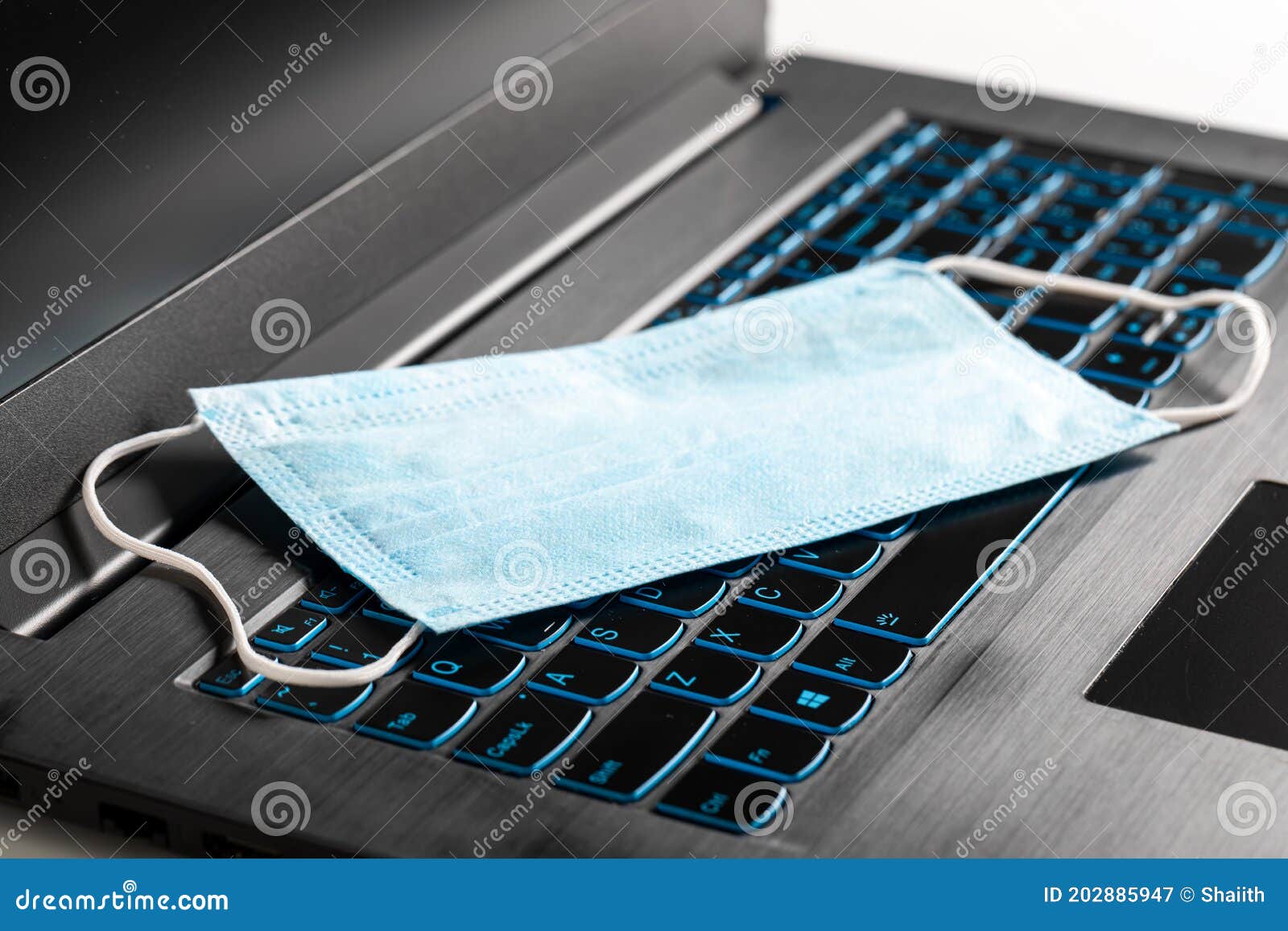 Protective Mask on Keyboard. Office Work from Home in Pandemic Stock ...