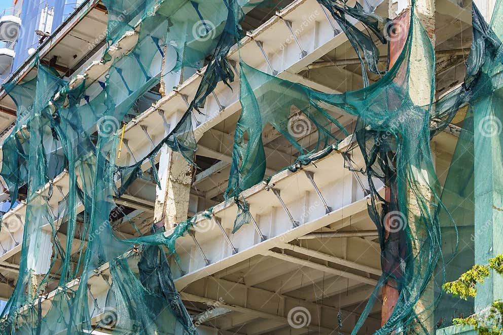 Protective Mesh on Scaffolding Torn by Hurricane Wind. Background with ...