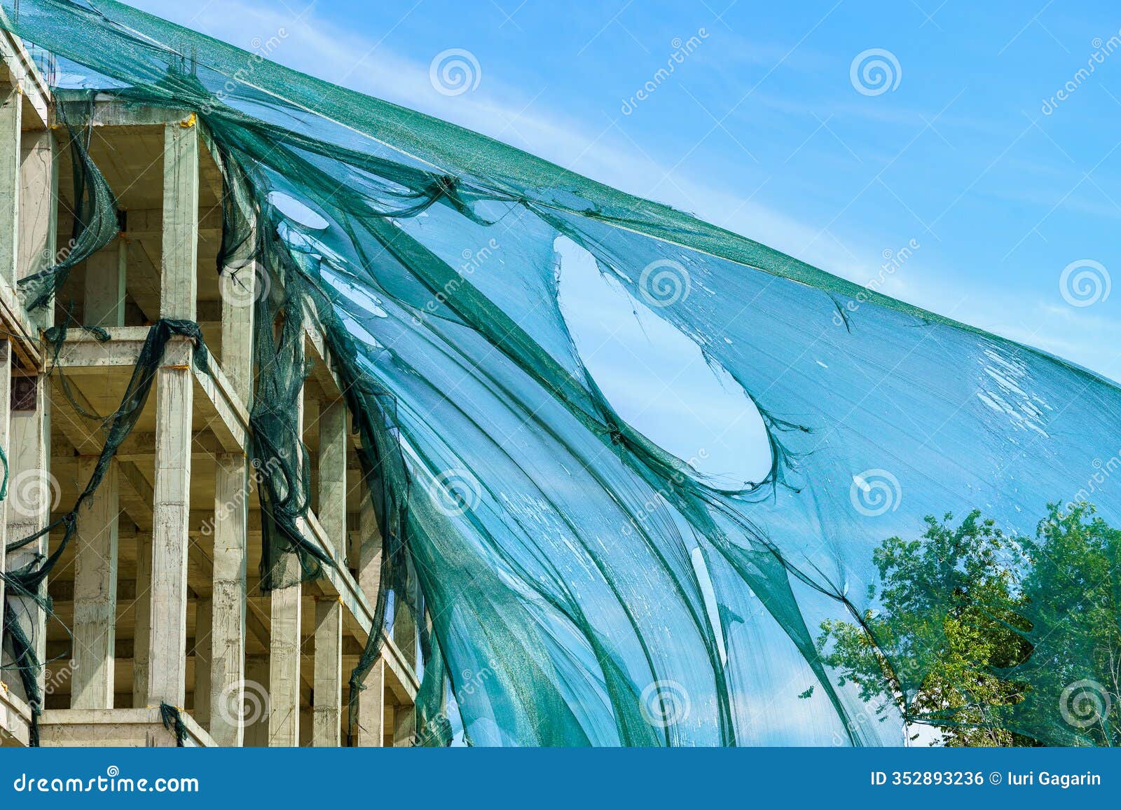 Protective Mesh on Scaffolding Torn by Hurricane Wind. Background with ...