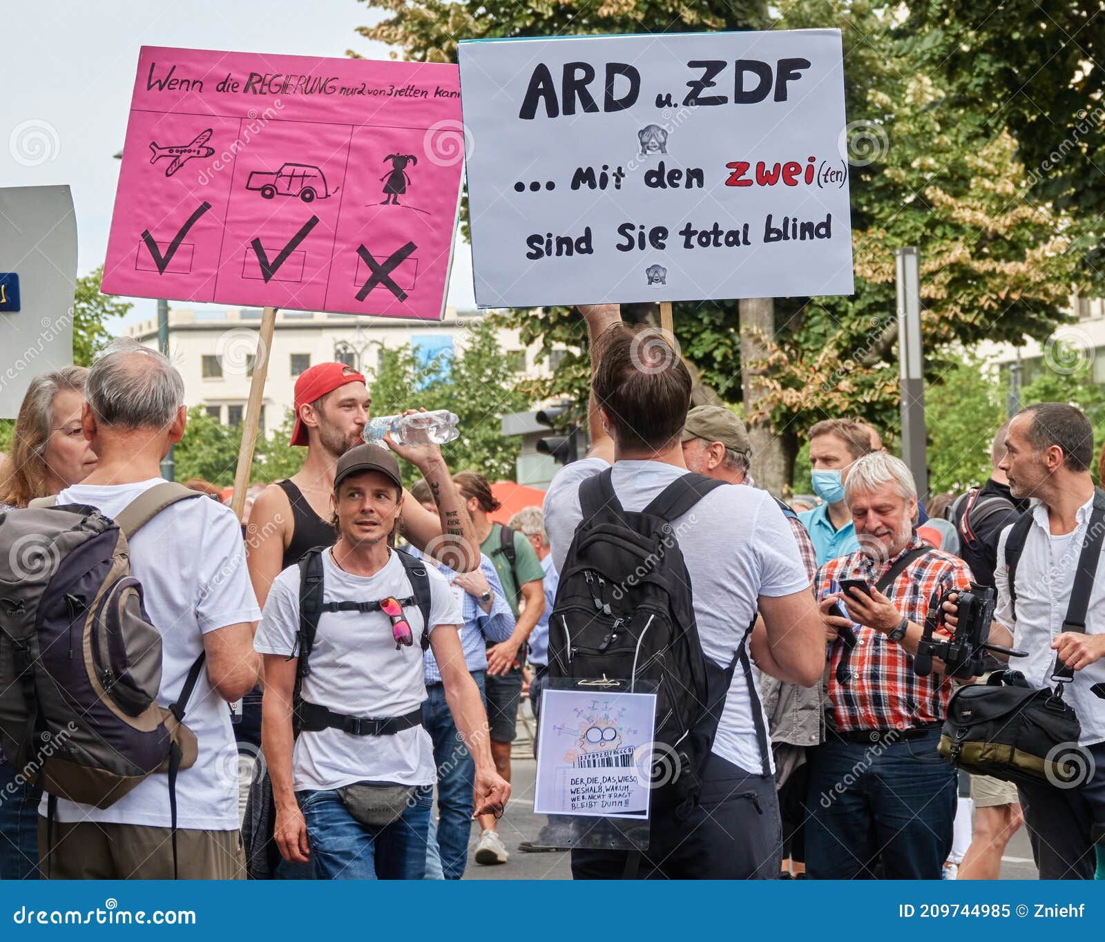 Protesters at the Anticorona Demonstration with Posters Questioning the ...