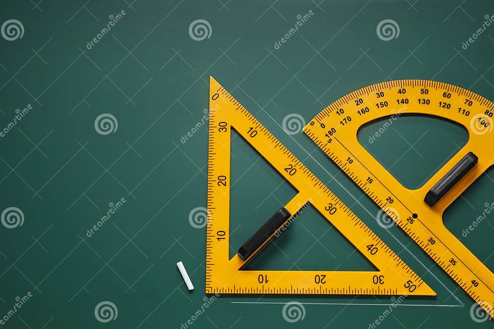 Protractor, Triangle and Chalk on Green Chalkboard, Flat Lay. Space for ...