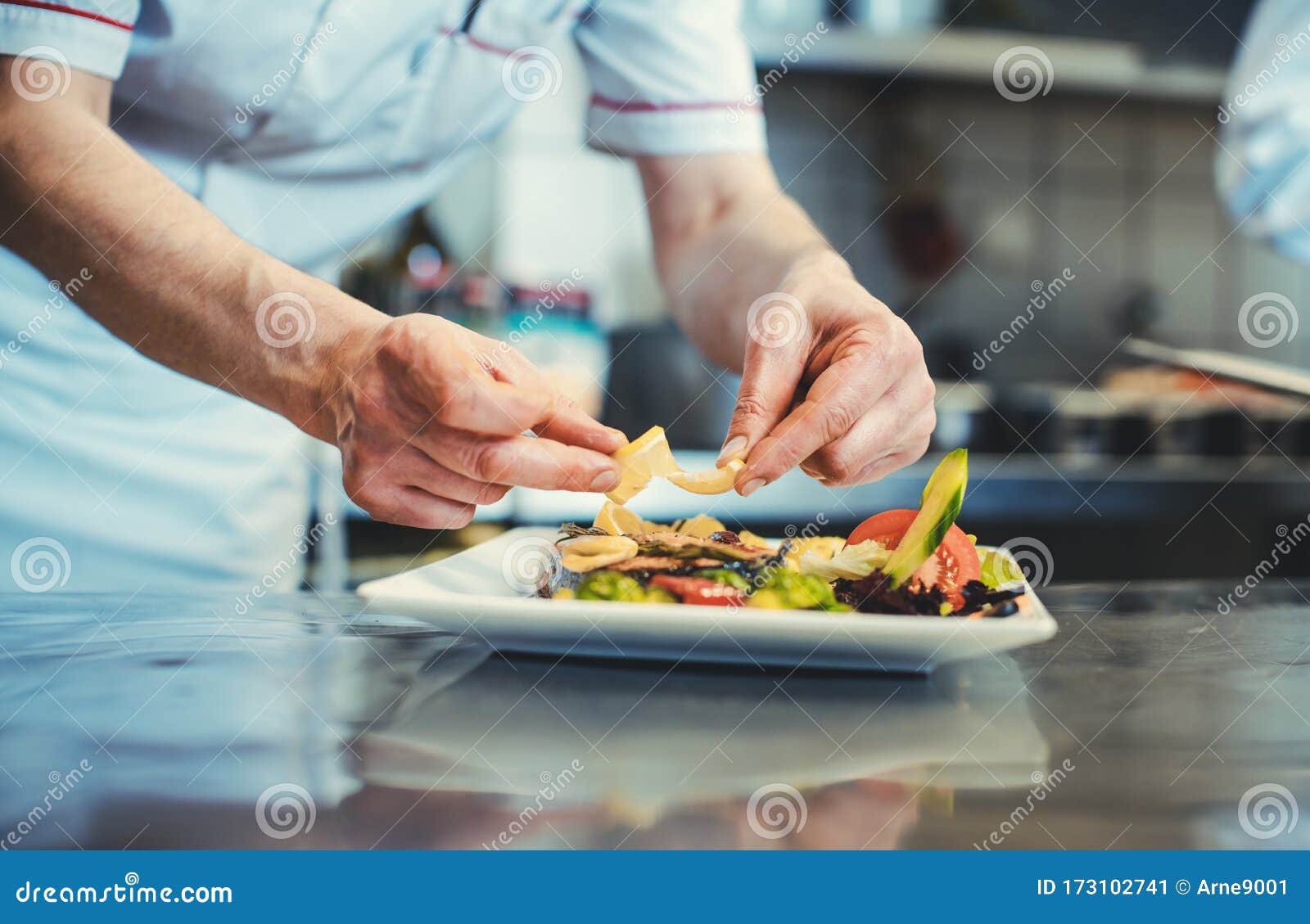 Proud Chef Garnishing an almost Finished Dish in the Restaurant with ...