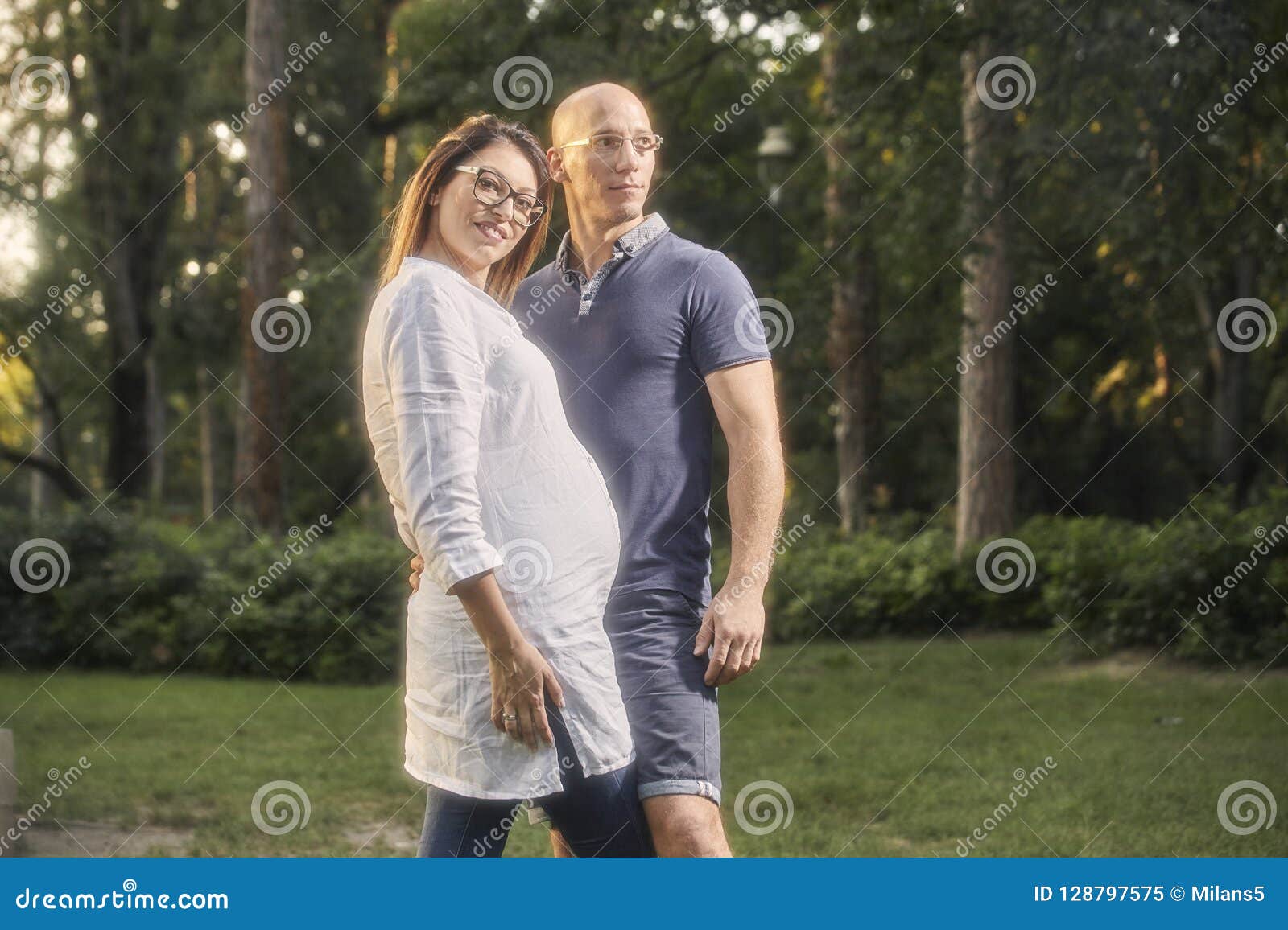 Posing Proud, Confident Young Couple, Standing Together in Park, Stock ... Posing Proud, Confident Young Couple, Standing Together in Park, Stock ...