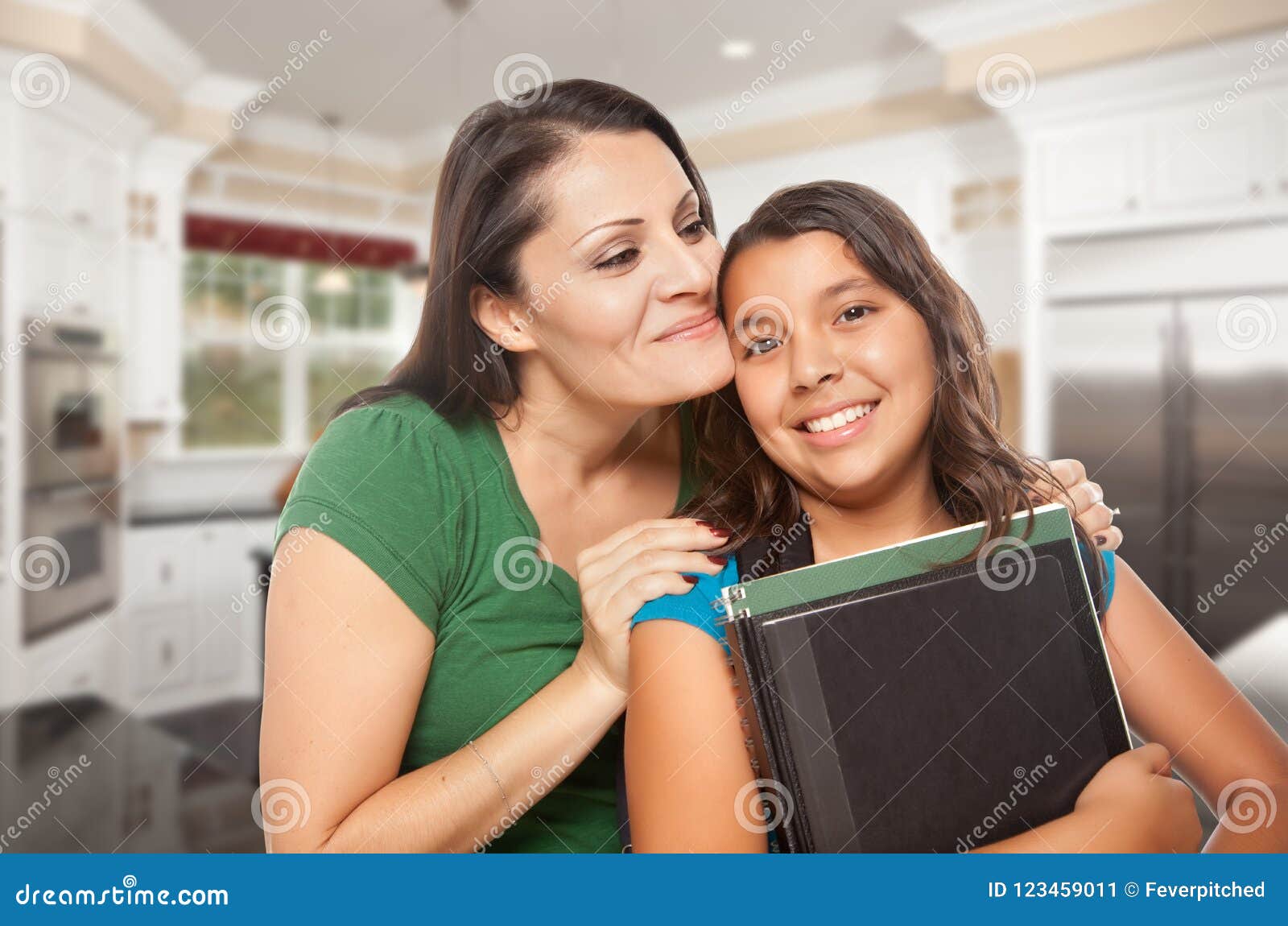 Proud Hispanic Mother and Daughter in Kitchen at Home Ready for Stock ...