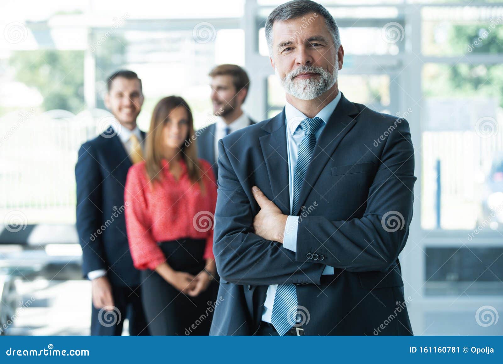 Proud Smiling Businessman Standing with His Colleagues at Office Stock ... Proud Smiling Businessman Standing with His Colleagues at Office Stock ...