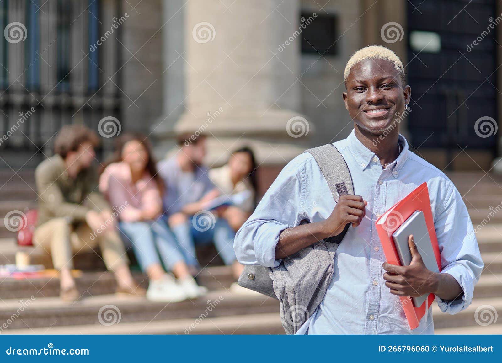 Proud Student with a Textbook Standing in Front of the University ...