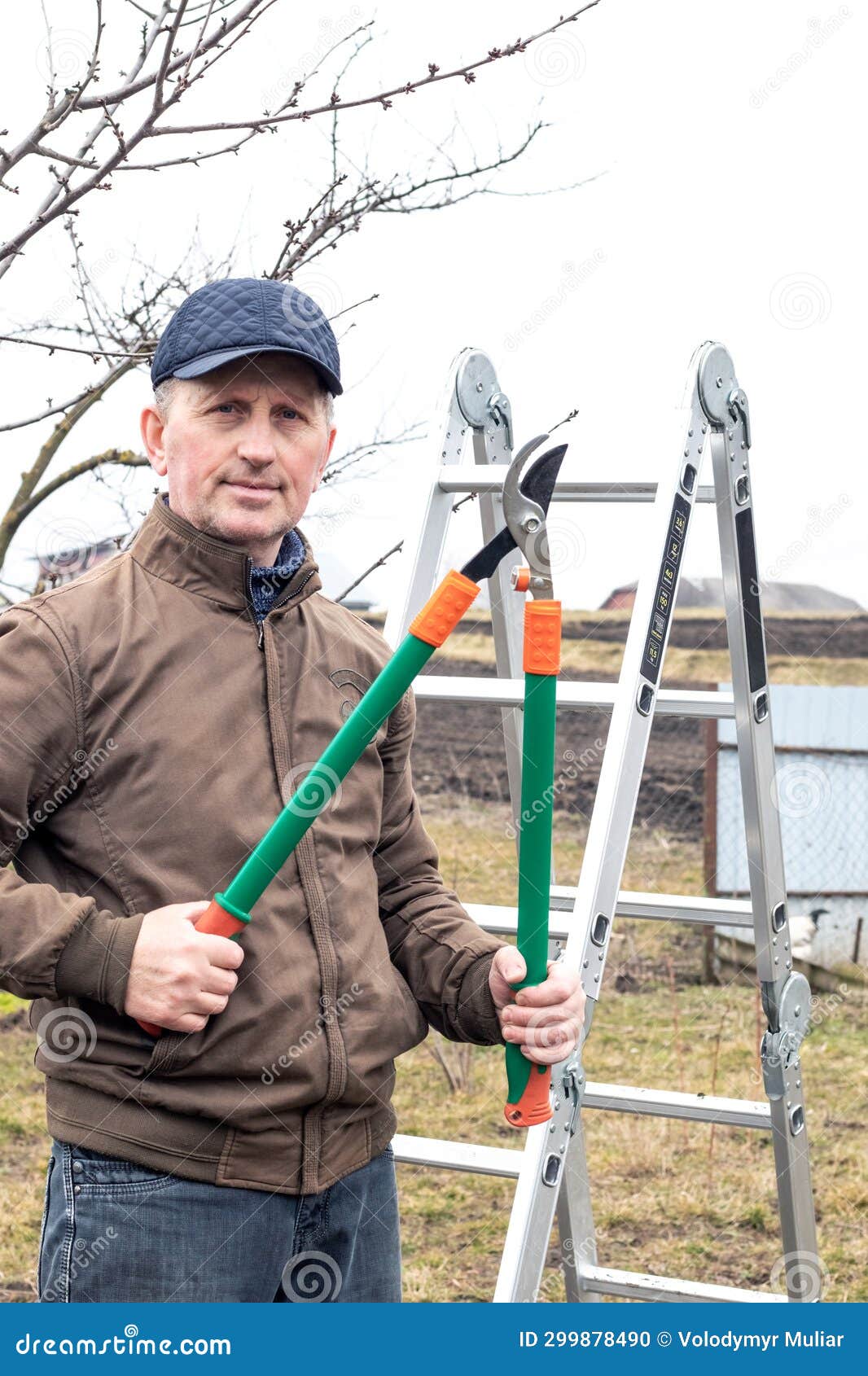Pruning Trees in Spring, Gardener with Big Shears in the Garden Near ...