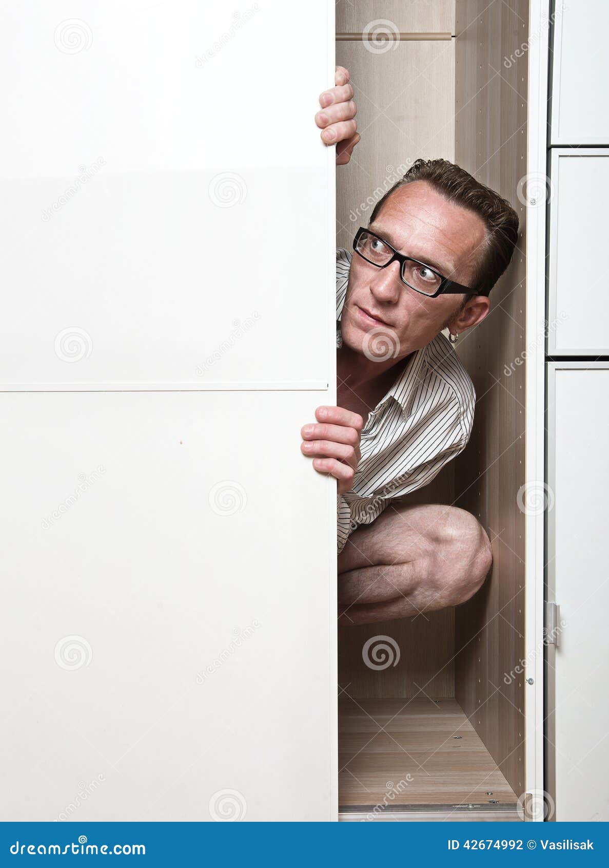 Prying Man Hiding Inside White Wardrobe Stock Photo - Image of ...