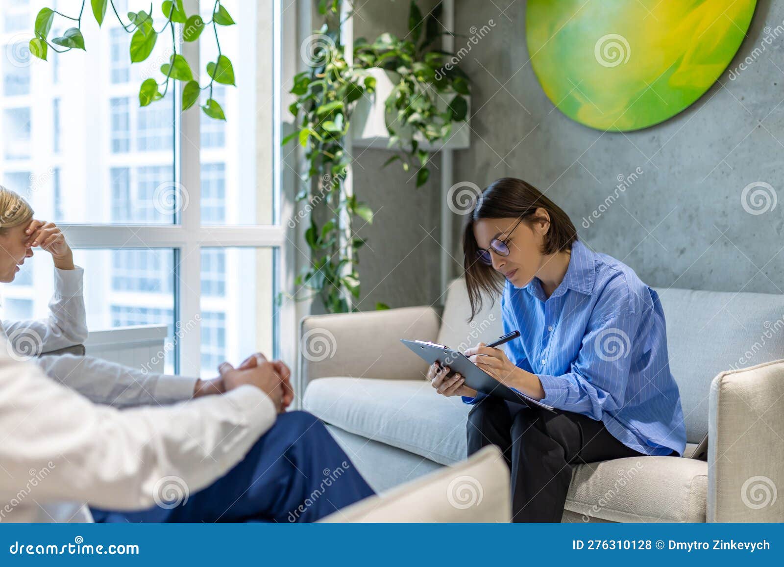 Psychologist Having a Sessiona with a Couple and Making Notes Stock ...