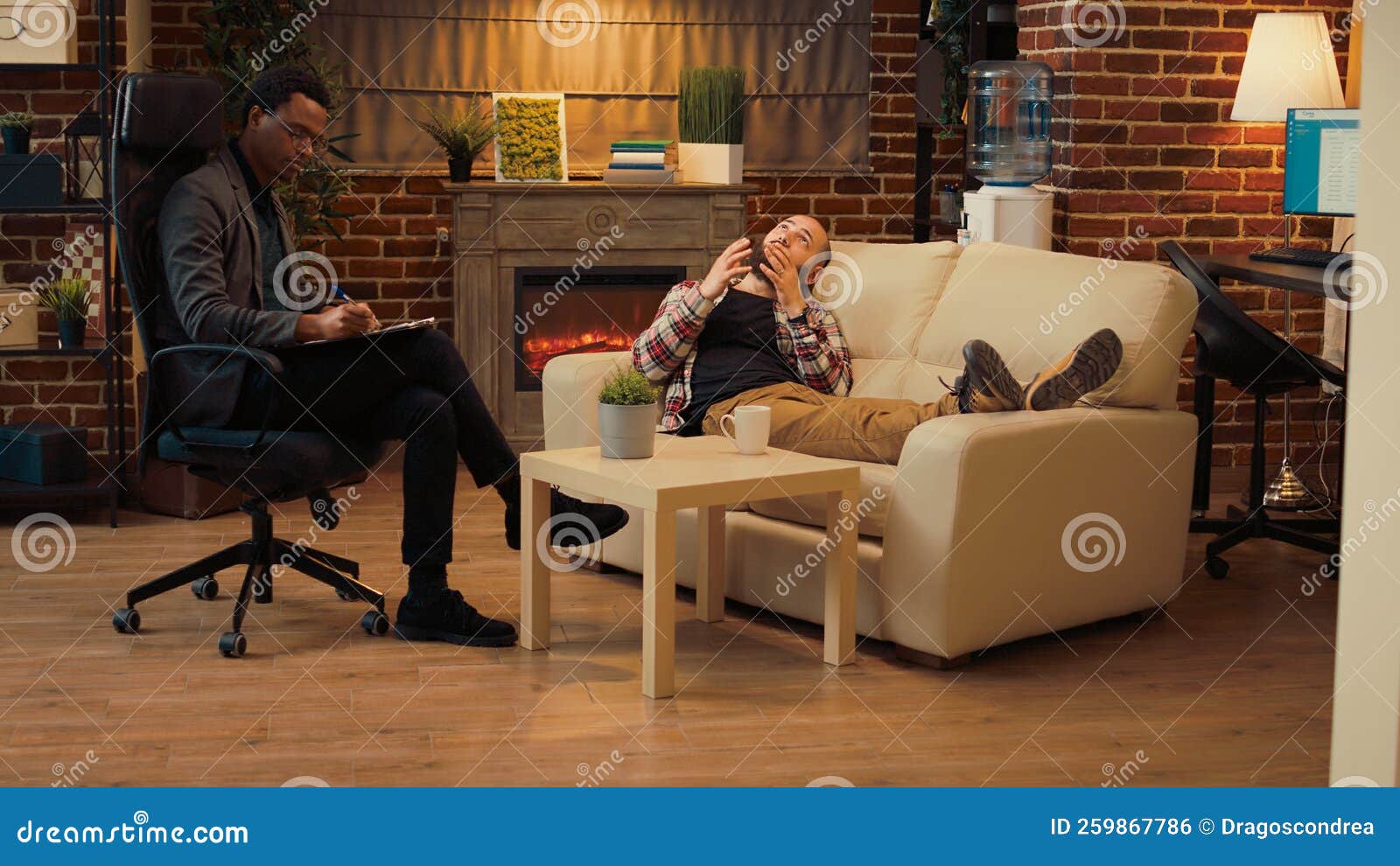 Psychologist Attending Therapy Session with Man Laying on Sofa Stock ...