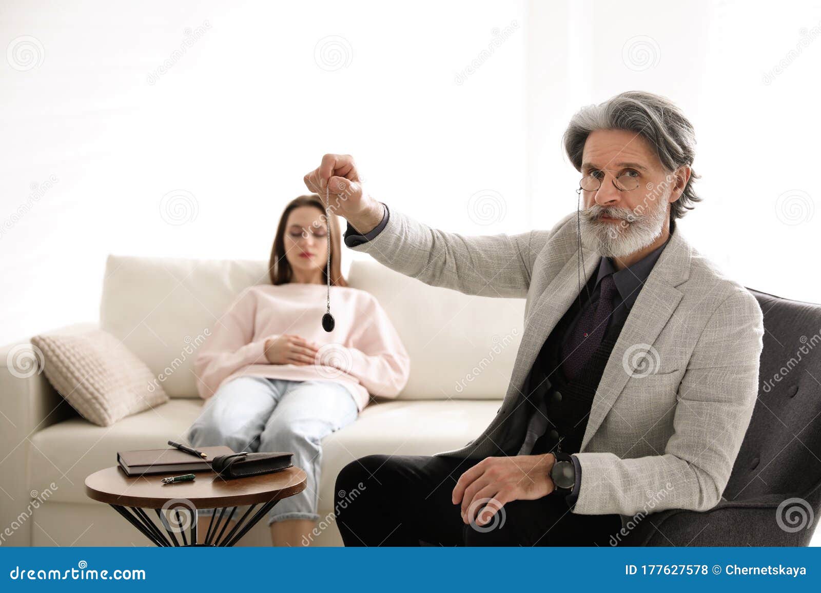 Psychotherapist Using Pendulum during Hypnotherapy Session Stock Photo ...