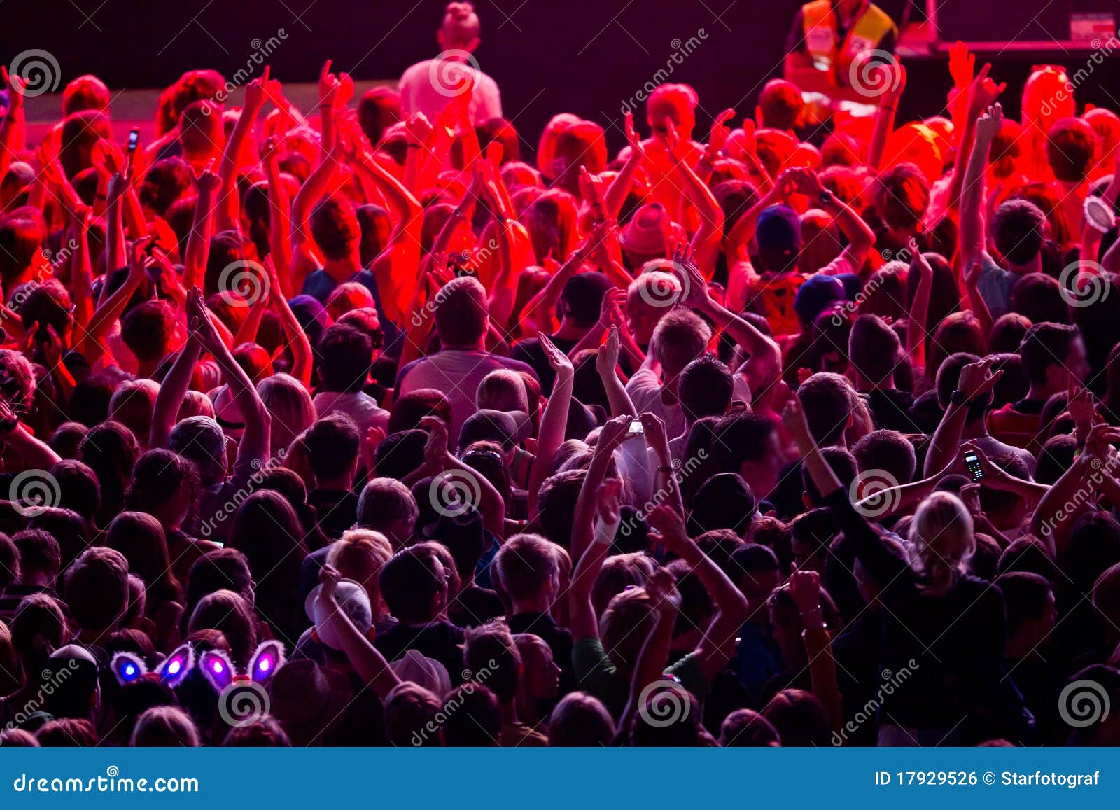 Public in red spotlight stock photo. Image of lights - 17929526
