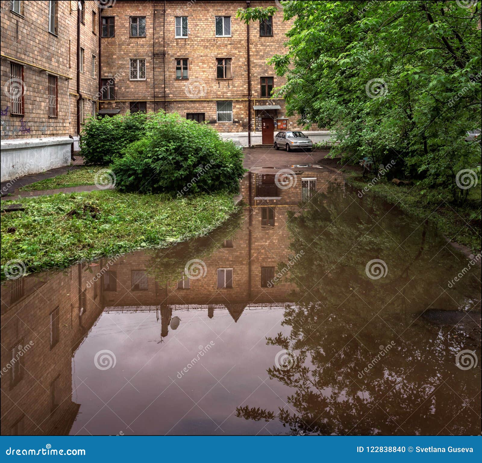 Puddle. City. Reflection stock photo. Image of town - 122838840