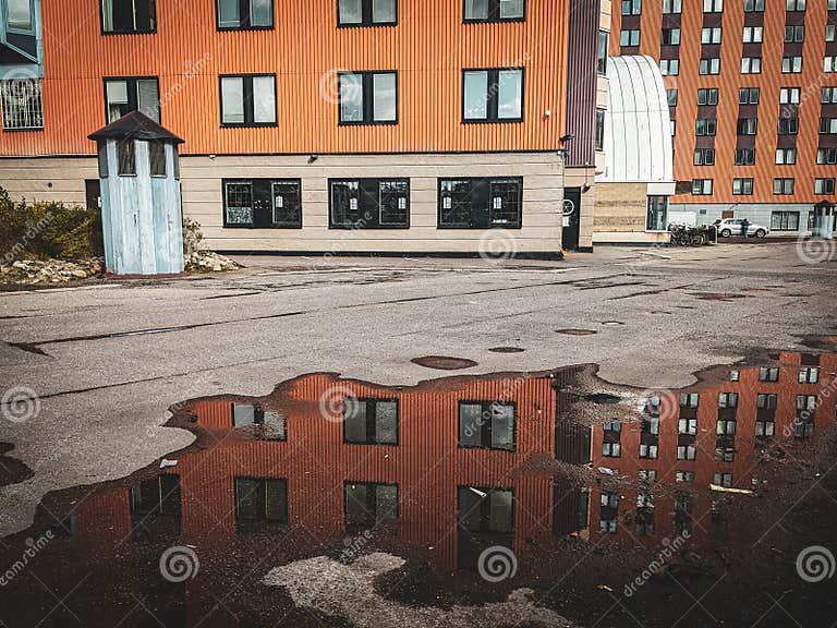 A Puddle in Front of Orange Building Stock Image - Image of outdoor ...