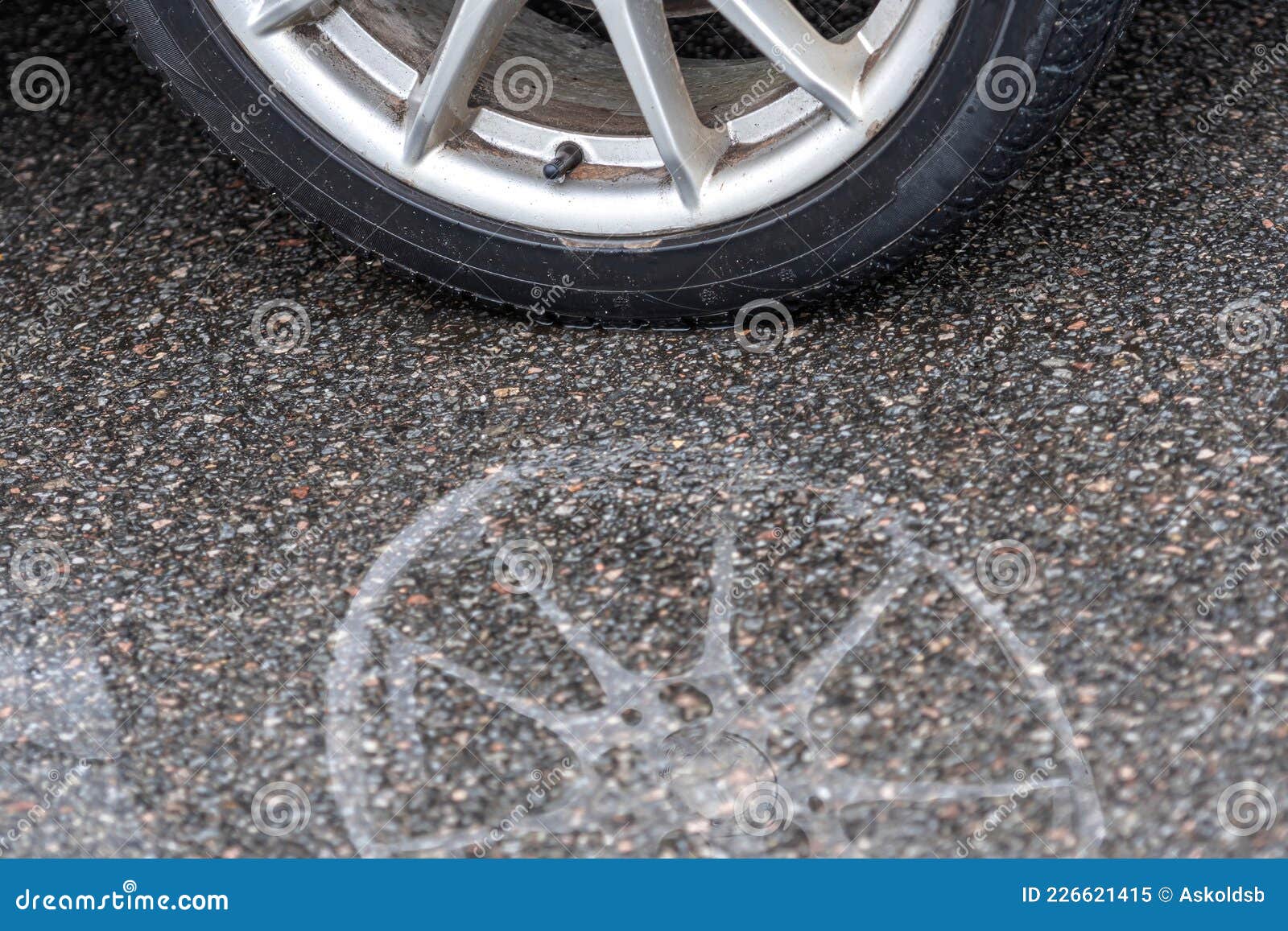 Puddle on the Pavement with a Reflection of the Car Wheel, Closeup ...