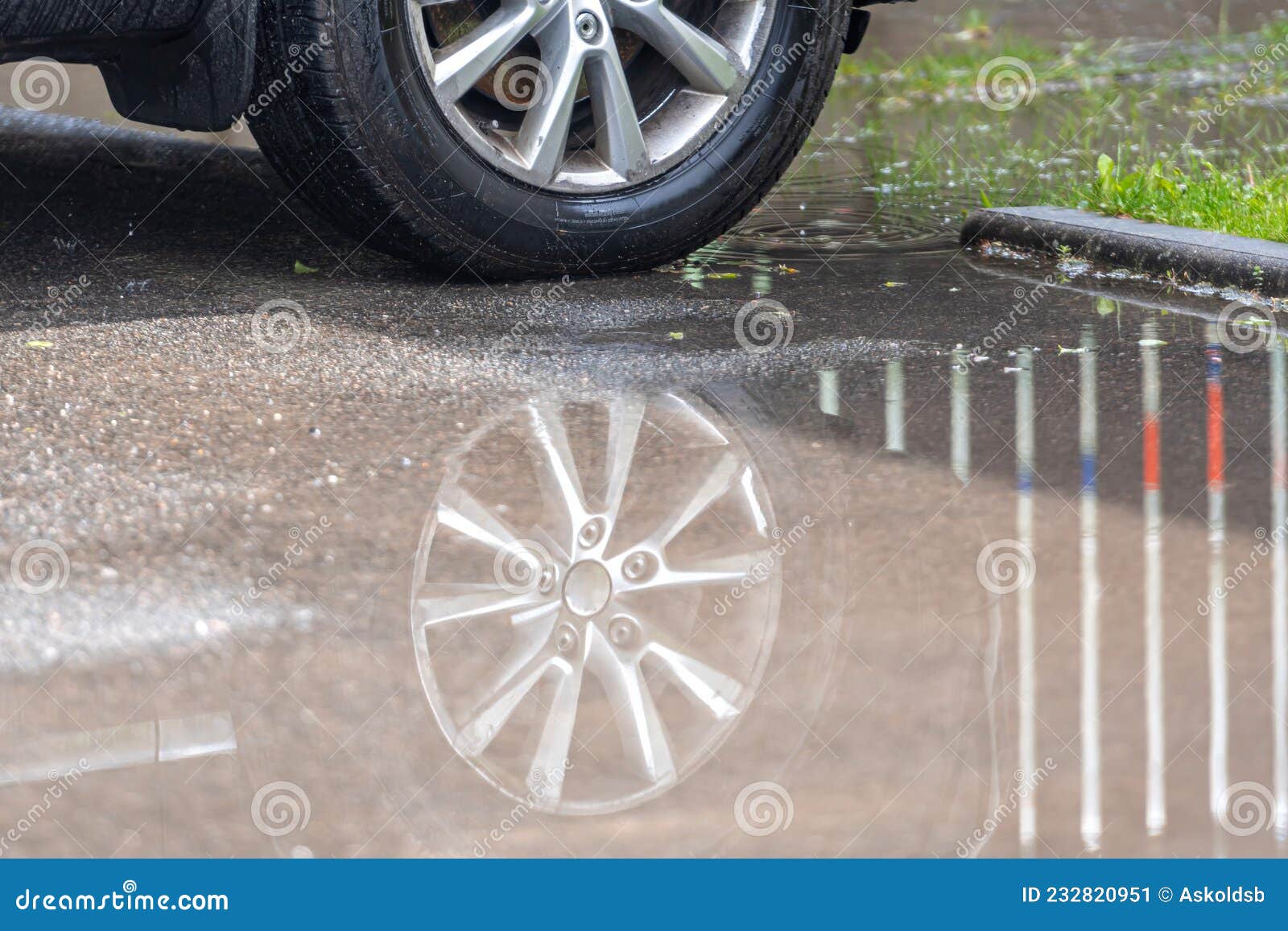 Puddle on the Pavement with a Reflection of the Car Wheel, Closeup ...
