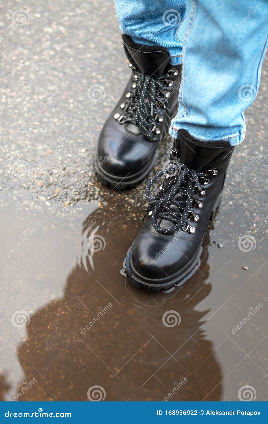 A Puddle on the Pavement Which is Entered with a Female Boot Stock ...