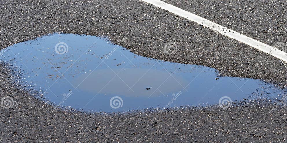 A Puddle in a Pit on an Asphalt Road. Stock Image - Image of abstract ...