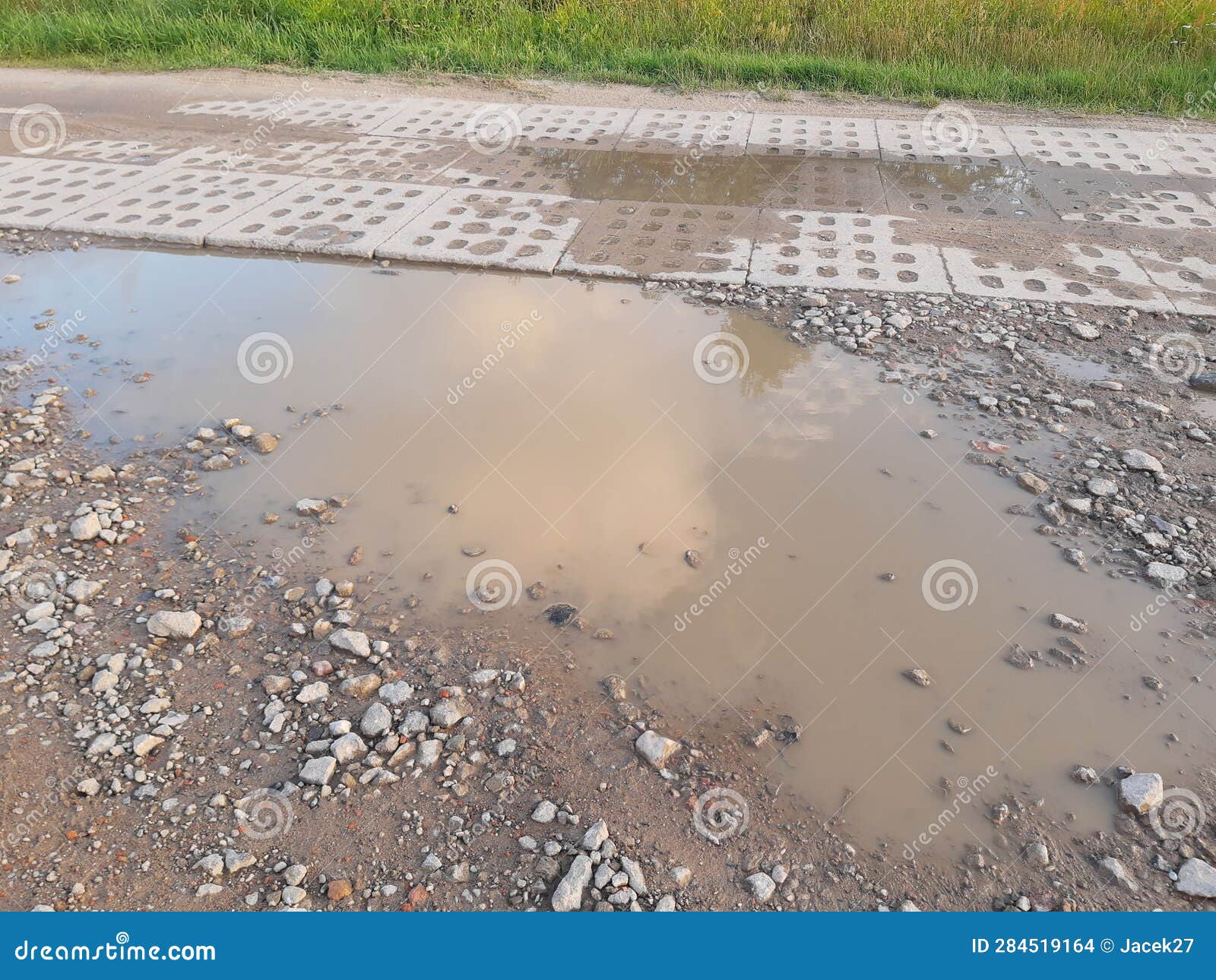 Puddle on the road stock photo. Image of pond, waterway - 284519164