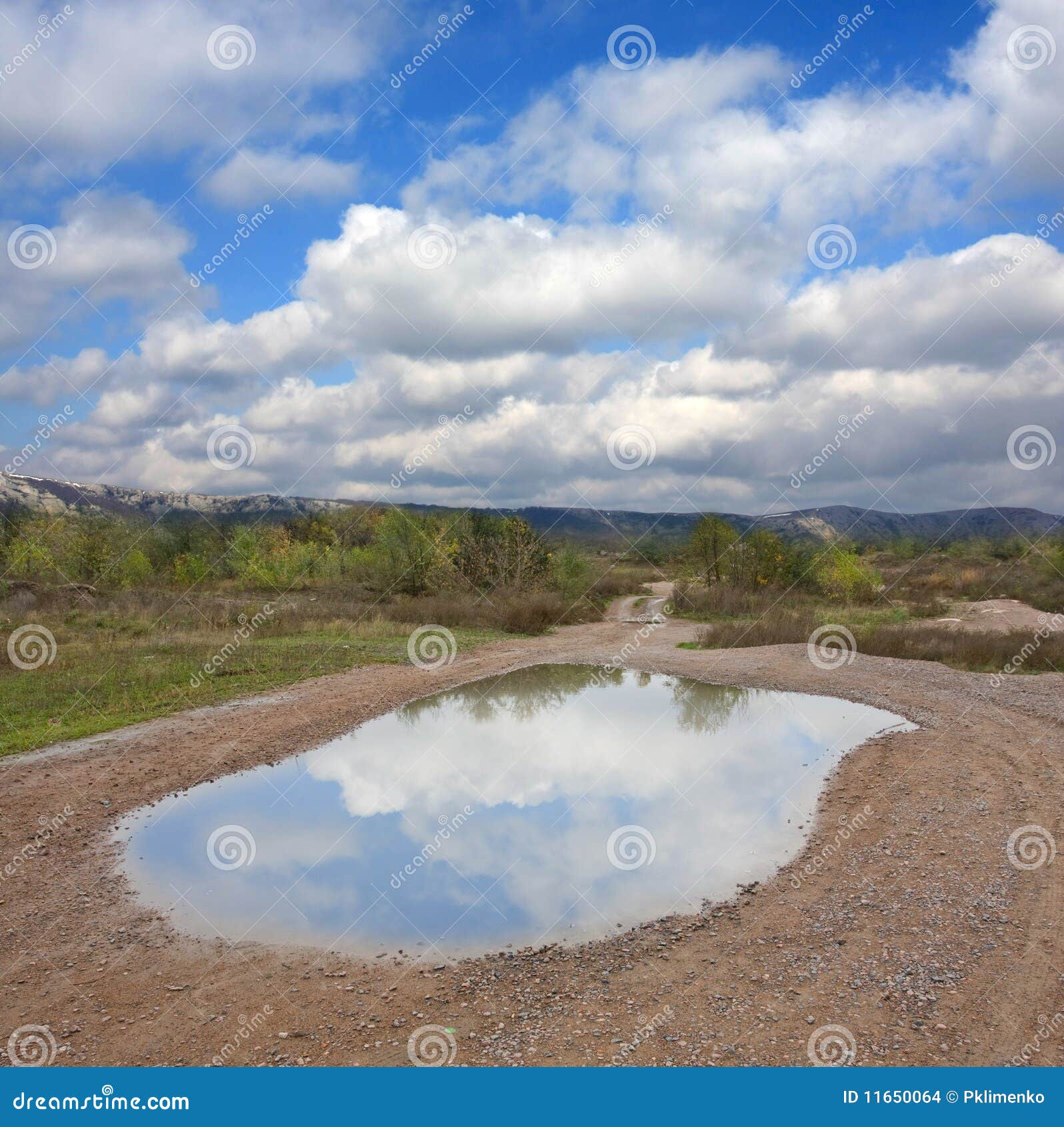 Puddle on road after rain stock photo. Image of gravel - 11650064
