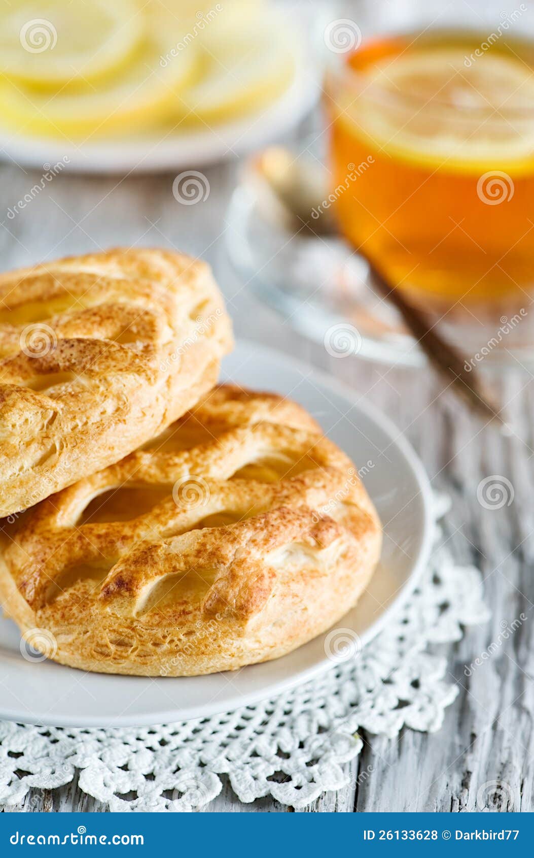 Puff Buns and Cup of Tea with Lemon Stock Photo - Image of citrus, bowl ...