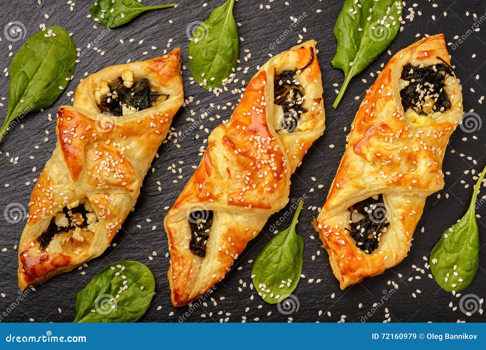 Puff Pastries with Spinach, Cheese and Sesame Seeds on Black Background ...